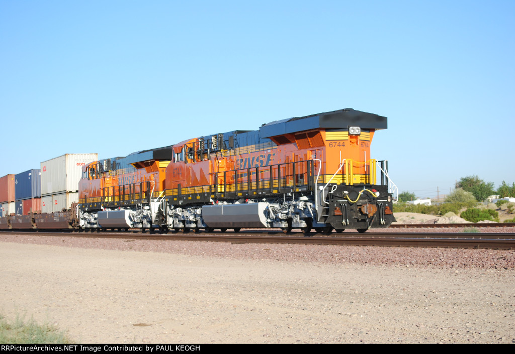 BNSF 6743 and BNSF 6744 Glisten in the Sun's Rays as they proceed west as Rear DPU's at 07:07 am ...